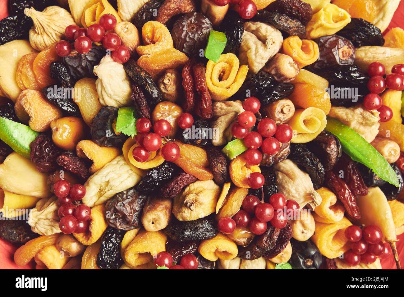 A lot of multi-colored delicious and nutritious dried fruits as ...