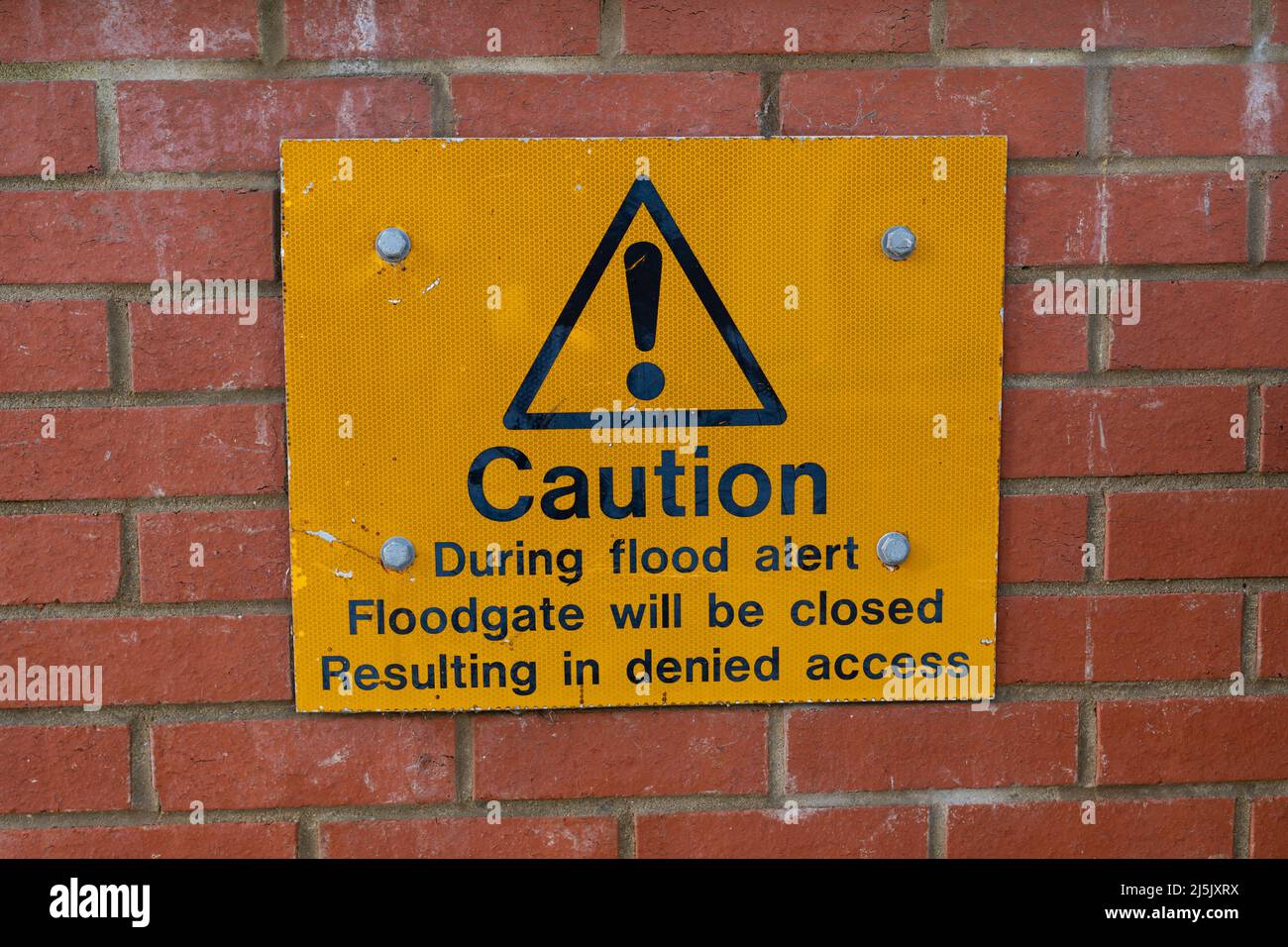 Warning sign informing the public that is a risk of a flood, the ...