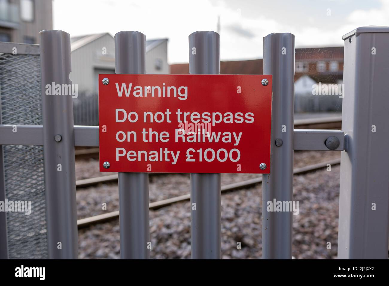 Warning sign next to train tracks informing the public not to trespass ...