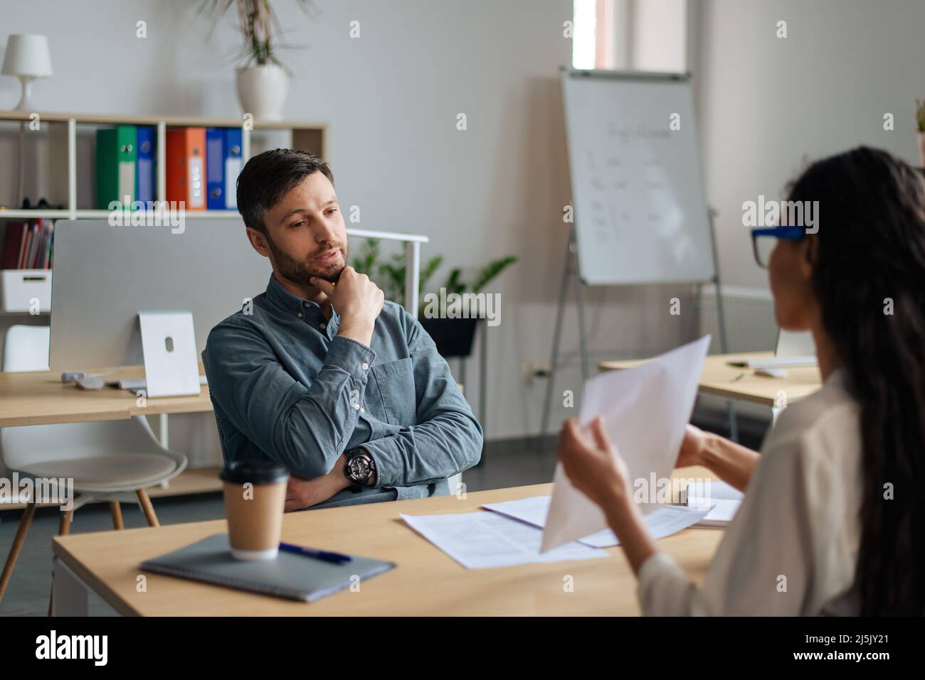 Vacancy candidate showing resume to hiring manager during job interview ...
