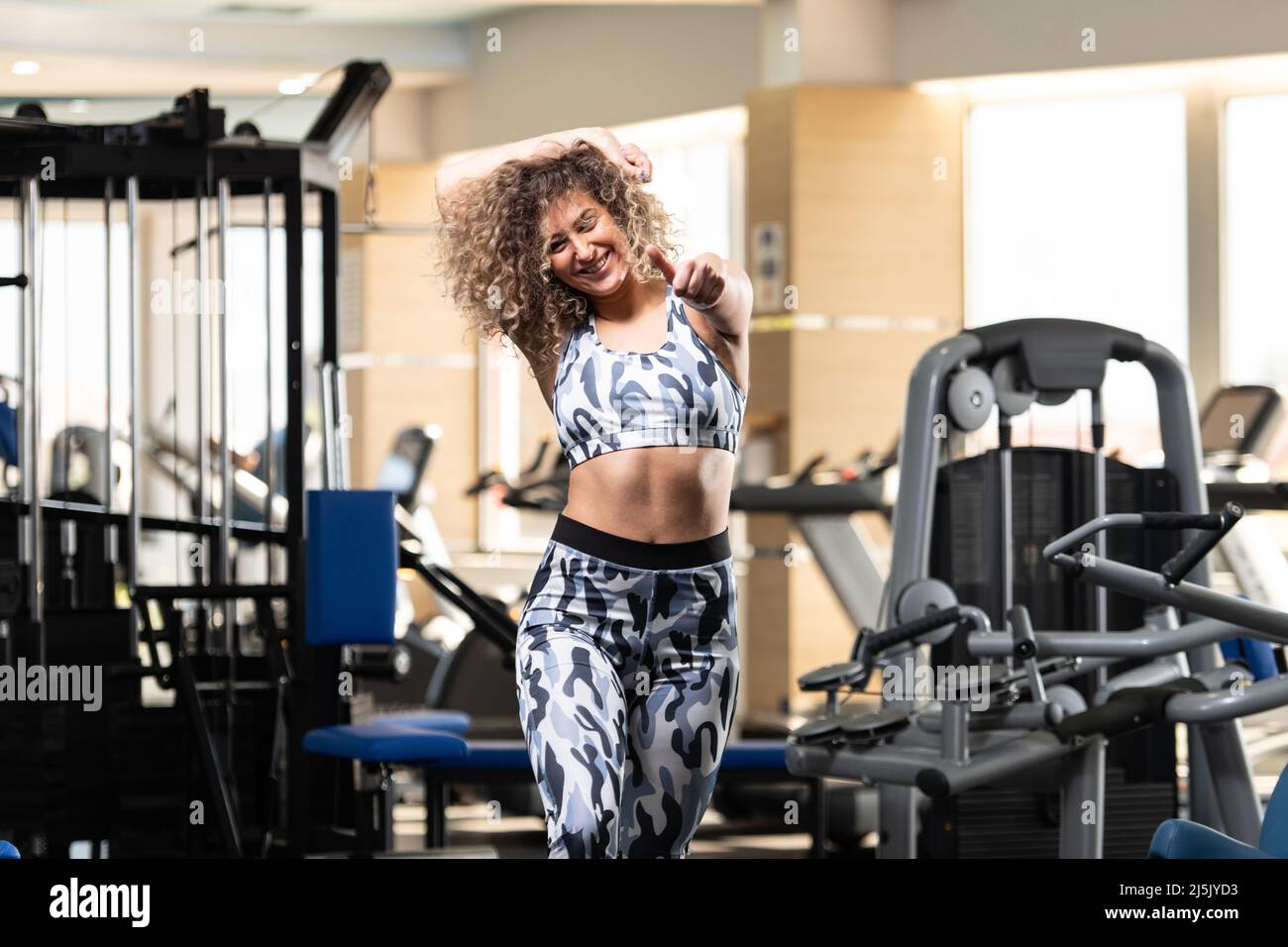 Healthy Young Woman Showing Thumbs Up While Standing Strong In The Gym ...