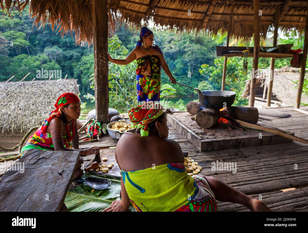 Embera puru indian woman are preparing and frying plantain in the Embera puru village, Republic ...
