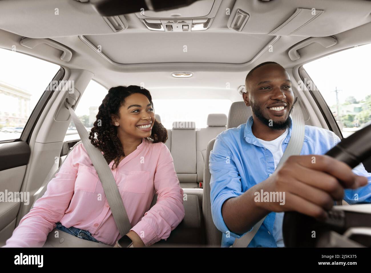 Happy black couple enjoying long drive on a car Stock Photo - Alamy
