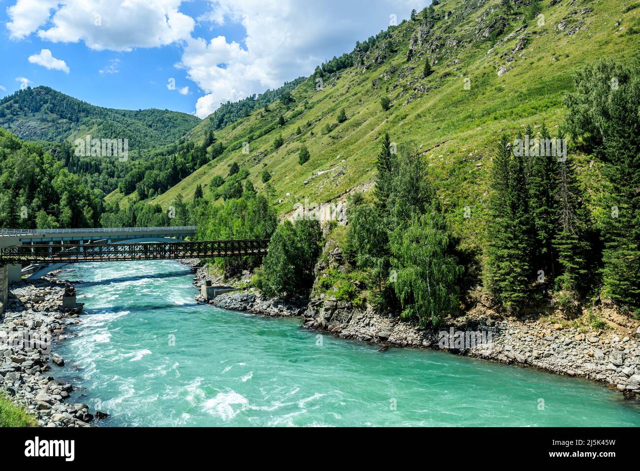 Green mountain and river natural landscape under blue sky in Xinjiang ...