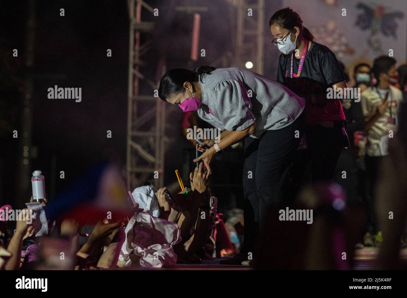Presidential aspirant Leni Robredo reaches out to a supporter as ...
