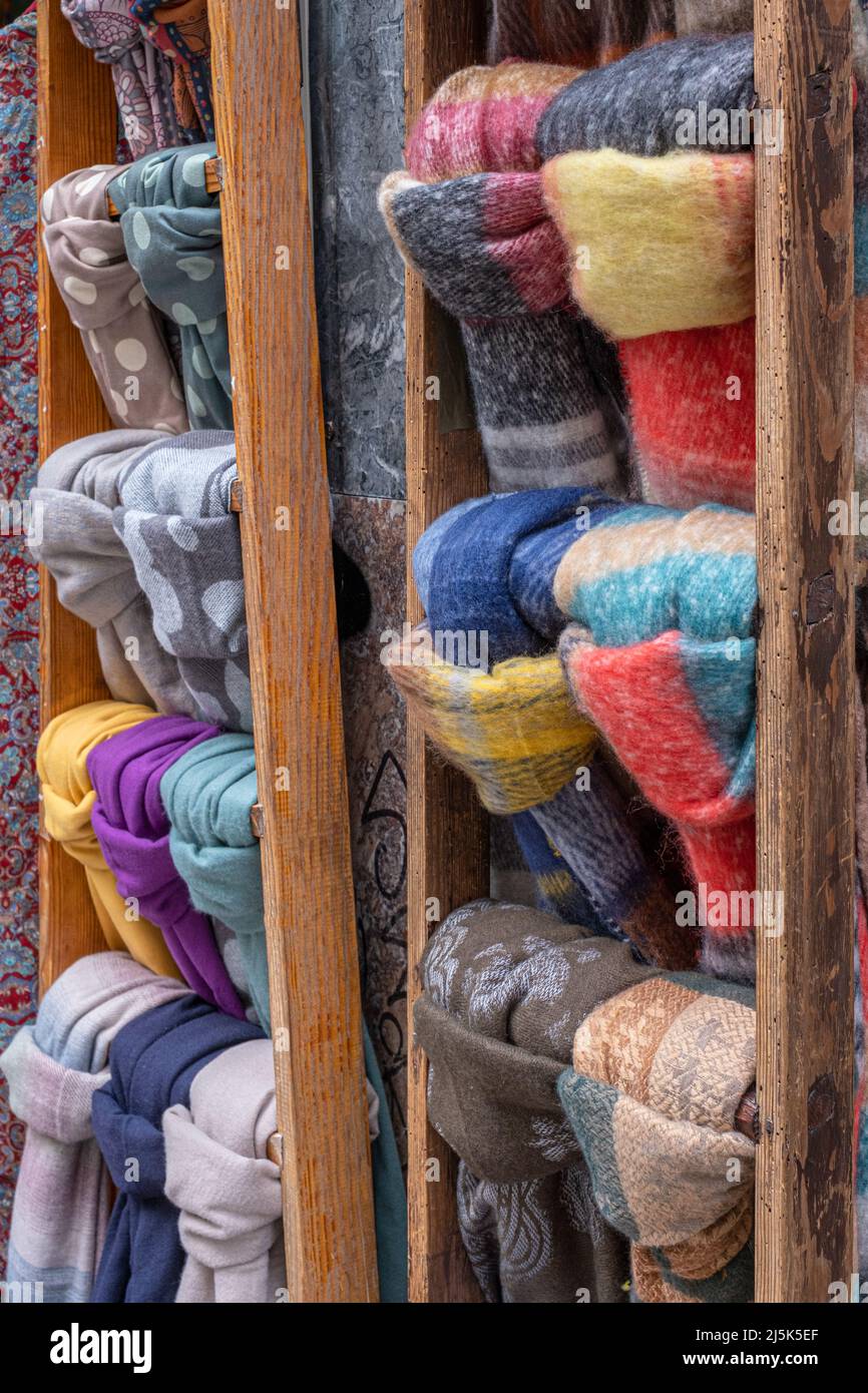 Natural wool knitted into colorful scarves on shelf Stock Photo - Alamy