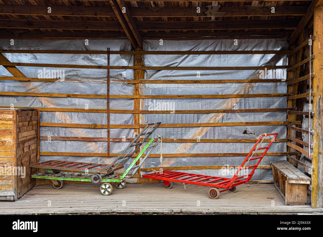 a manual cart for transporting goods stands in a barn. High quality ...
