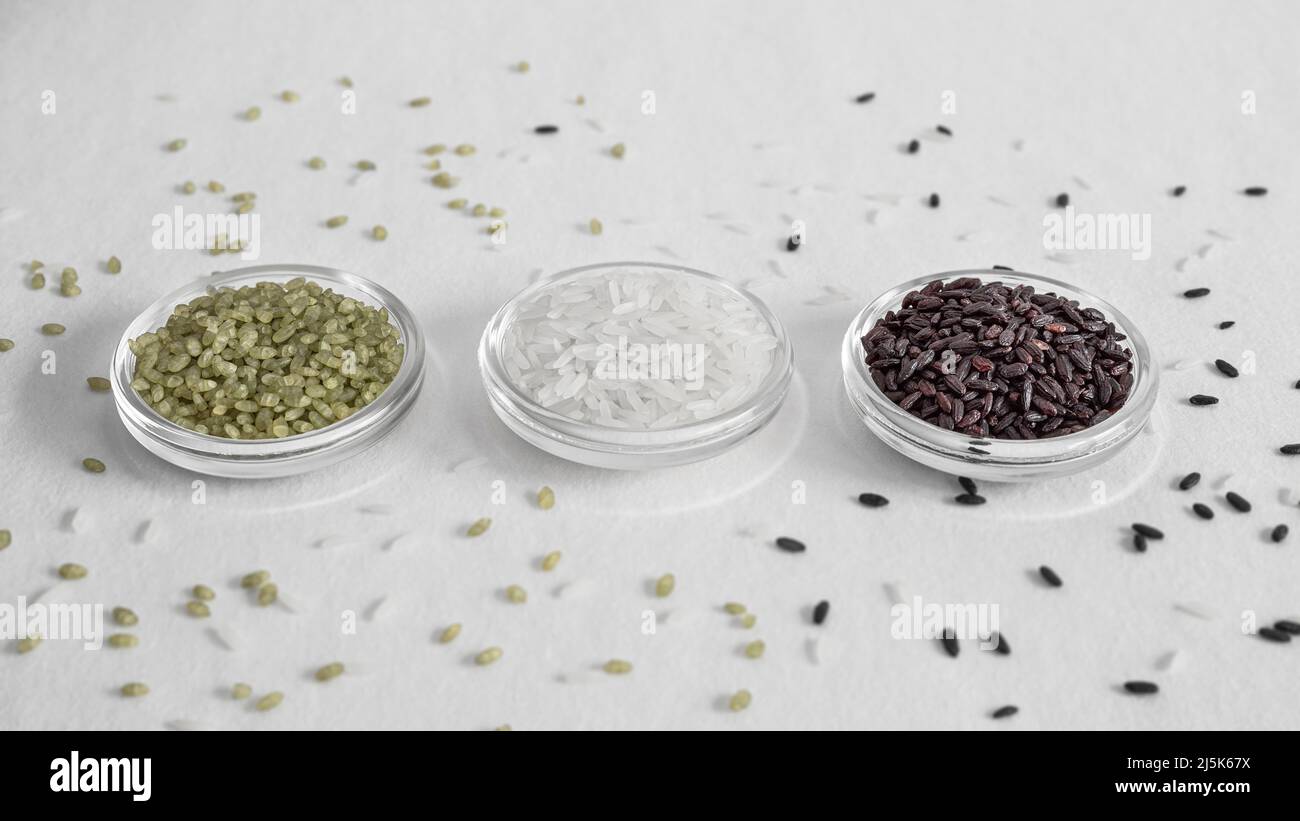 Three varieties of rice, green, white and black, in glass bowls Stock ...