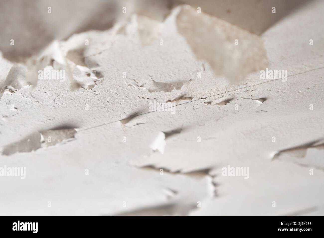 Peeling paint due to dampness on the bathroom ceiling after a water ...