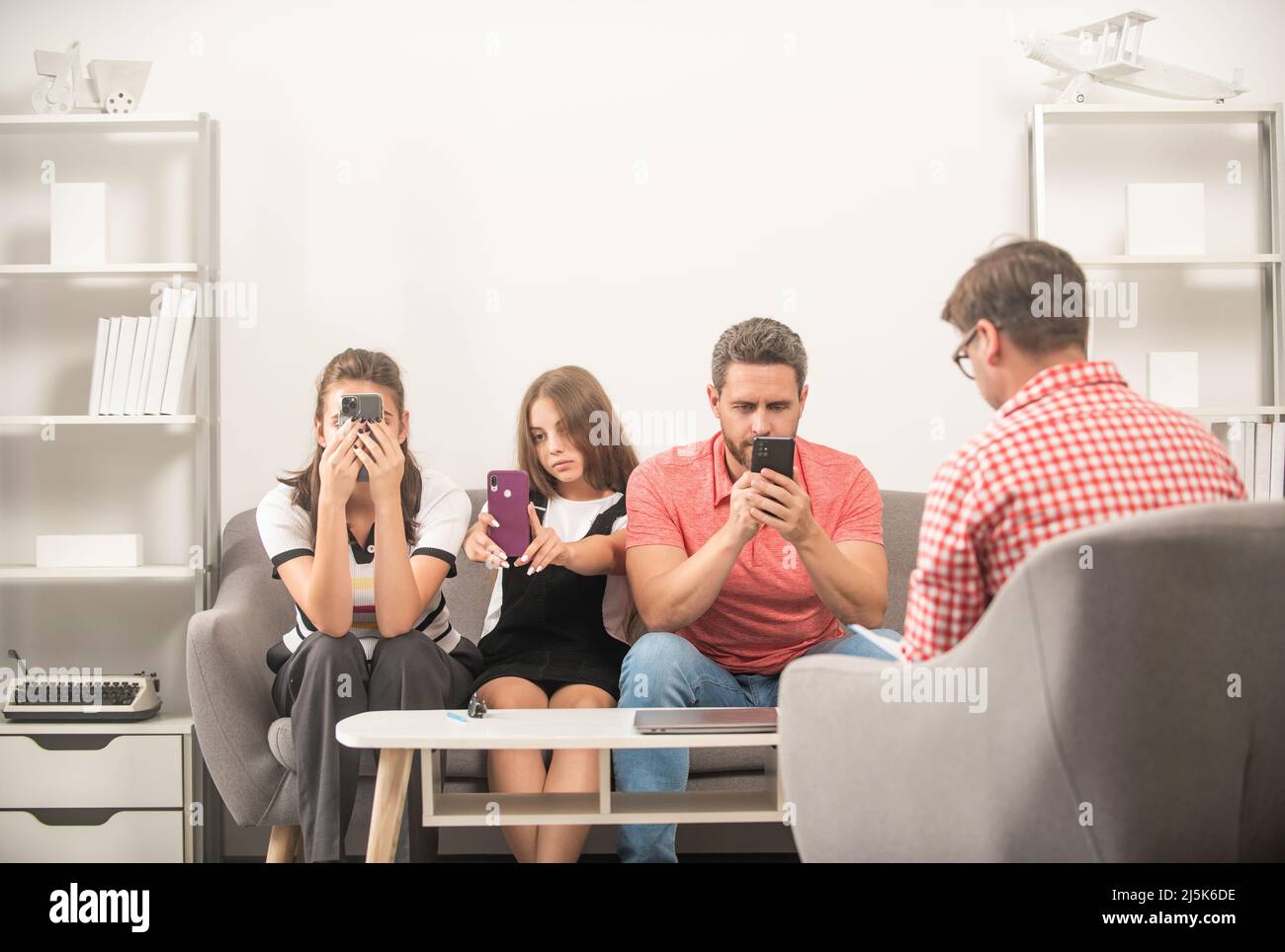 phone addicted father mother and child at family psychologist ...