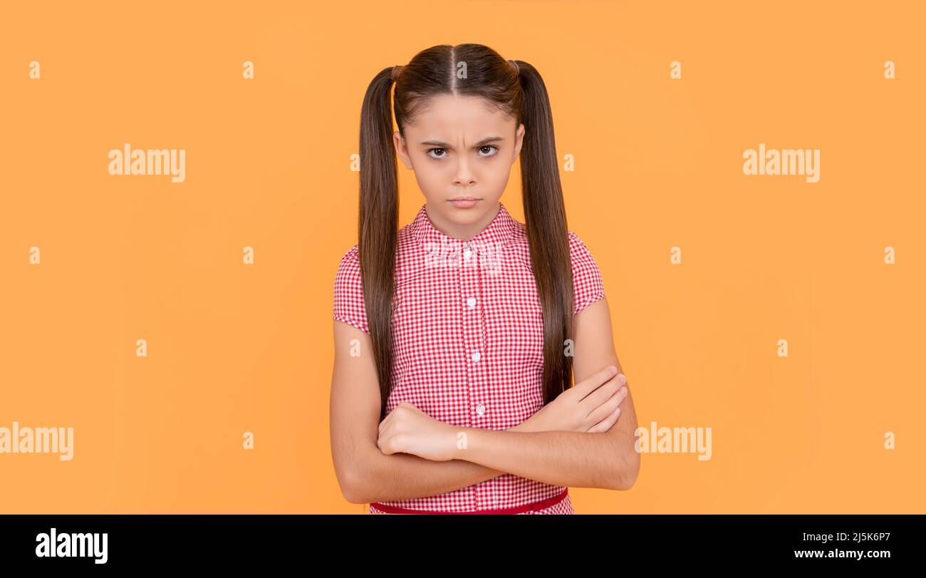 Frown kid keep arms crossed being in bad mood orange background ...
