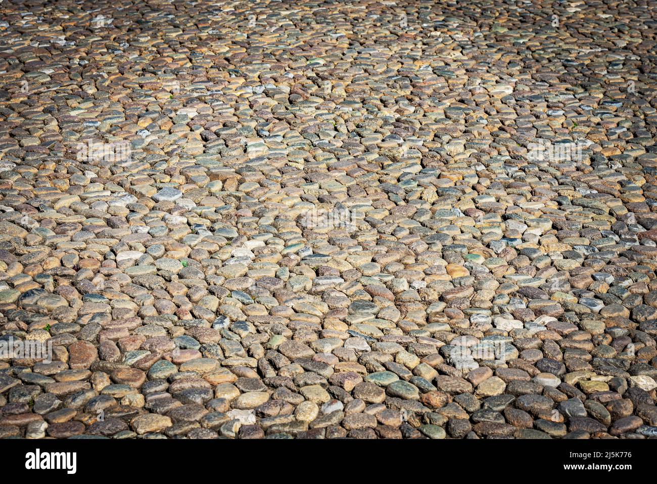 Close-up of a paving stone made of small cobblestones in Brescia ...