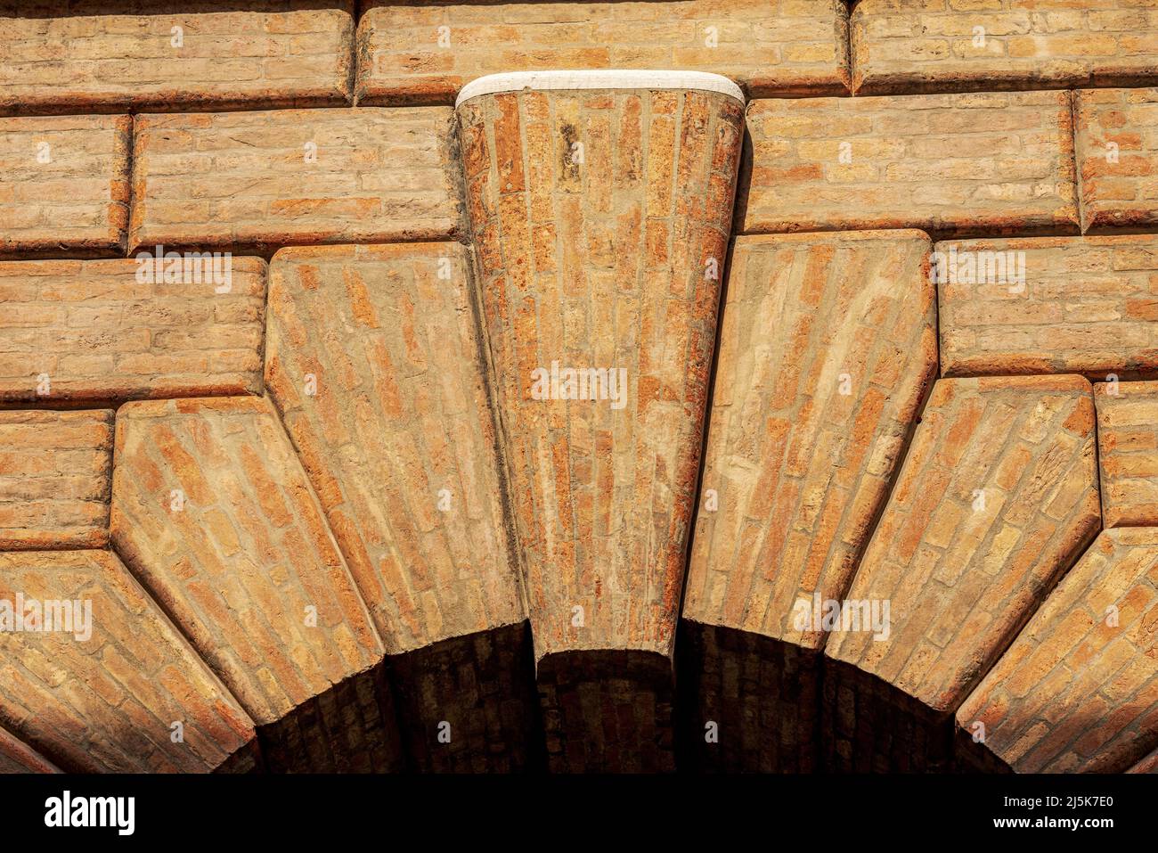 Close-up of a medieval arch made of bricks with keystone with the ...