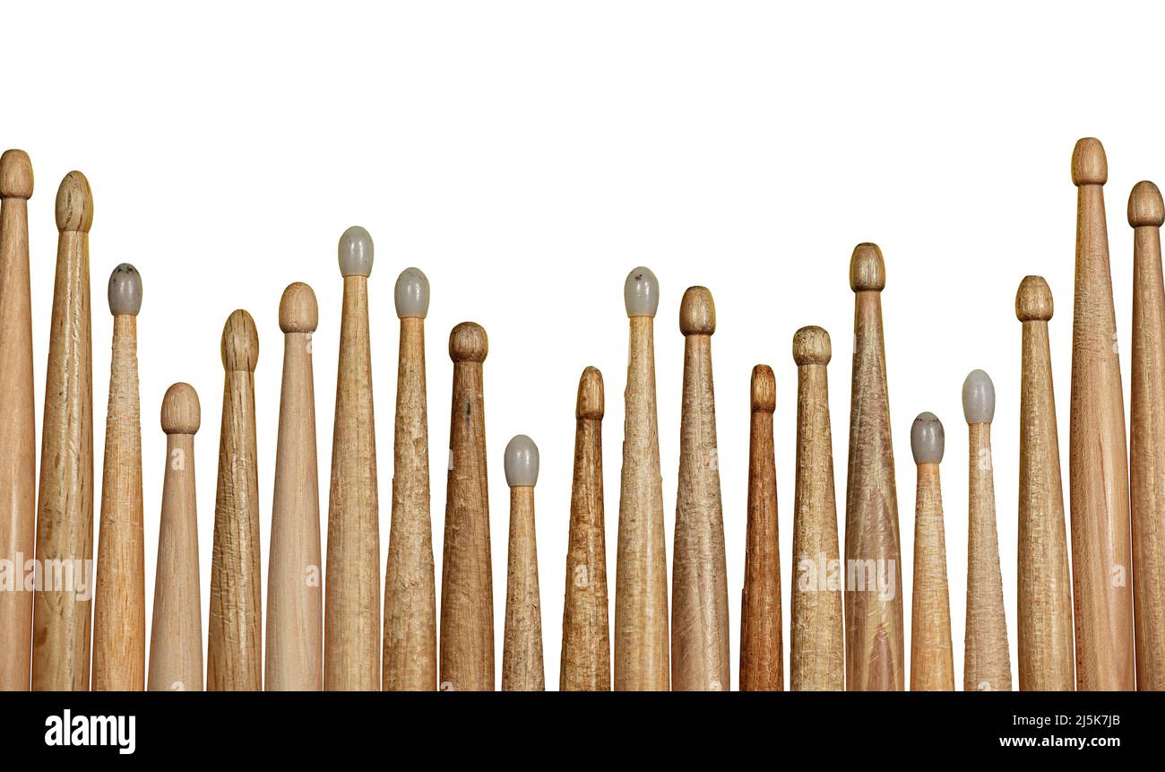 Close-up of a large group of used wooden drumsticks isolated on white ...