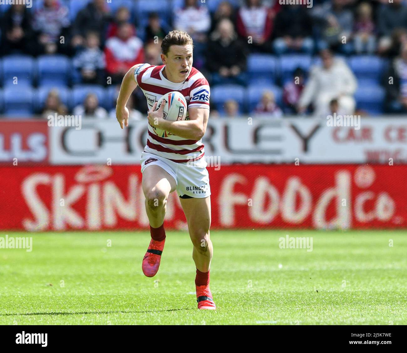 Jai Field #23 of Wigan Warriors runs forward with the ball Stock Photo ...