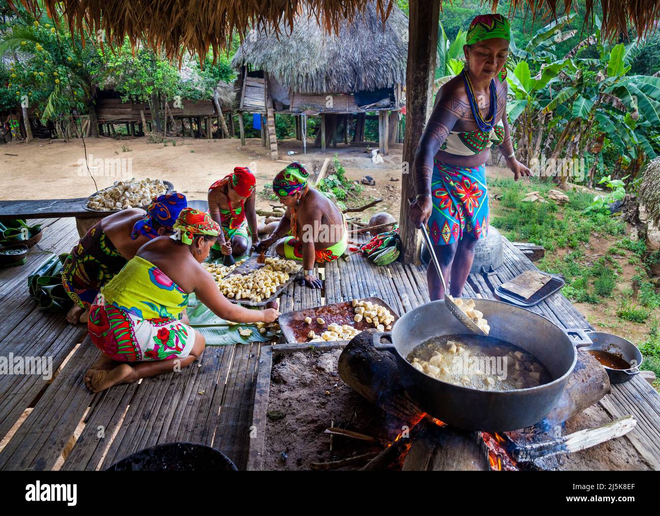 Embera Puru indian woman are preparing and frying plantain in the Embera Puru village beside Rio ...