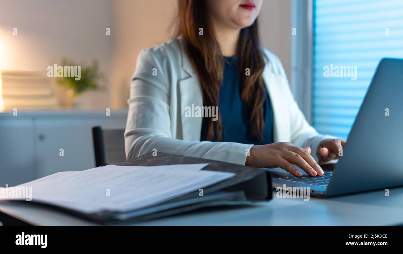 Overwork Concept The female working in the office and typing something ...
