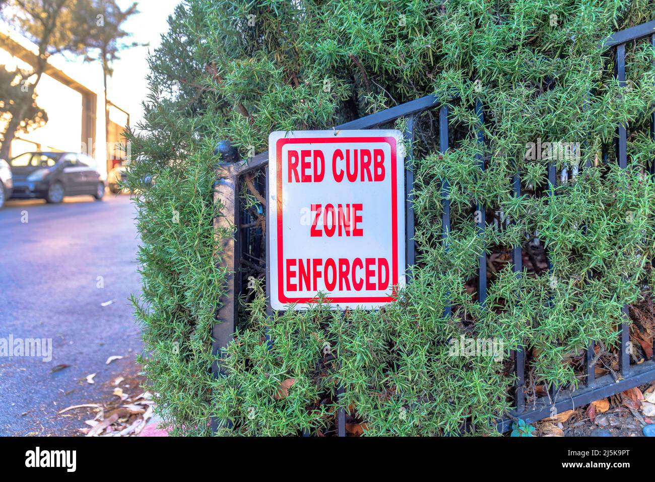 Red curb zone enforced signage beside the road in San Francisco ...