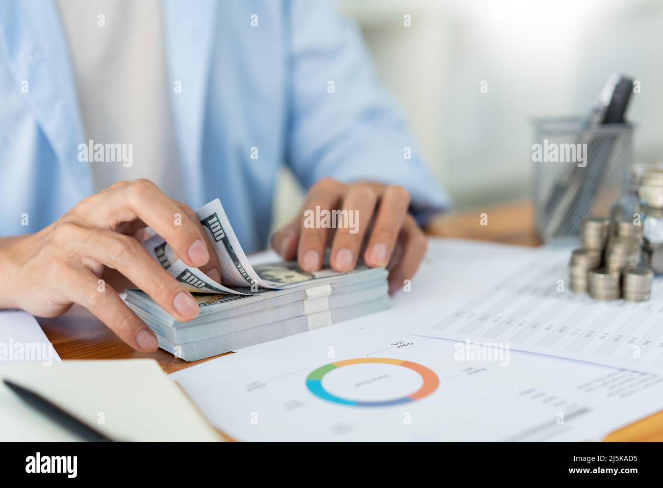 Saving concept the money gatherer sitting and counting his pile of cash ...