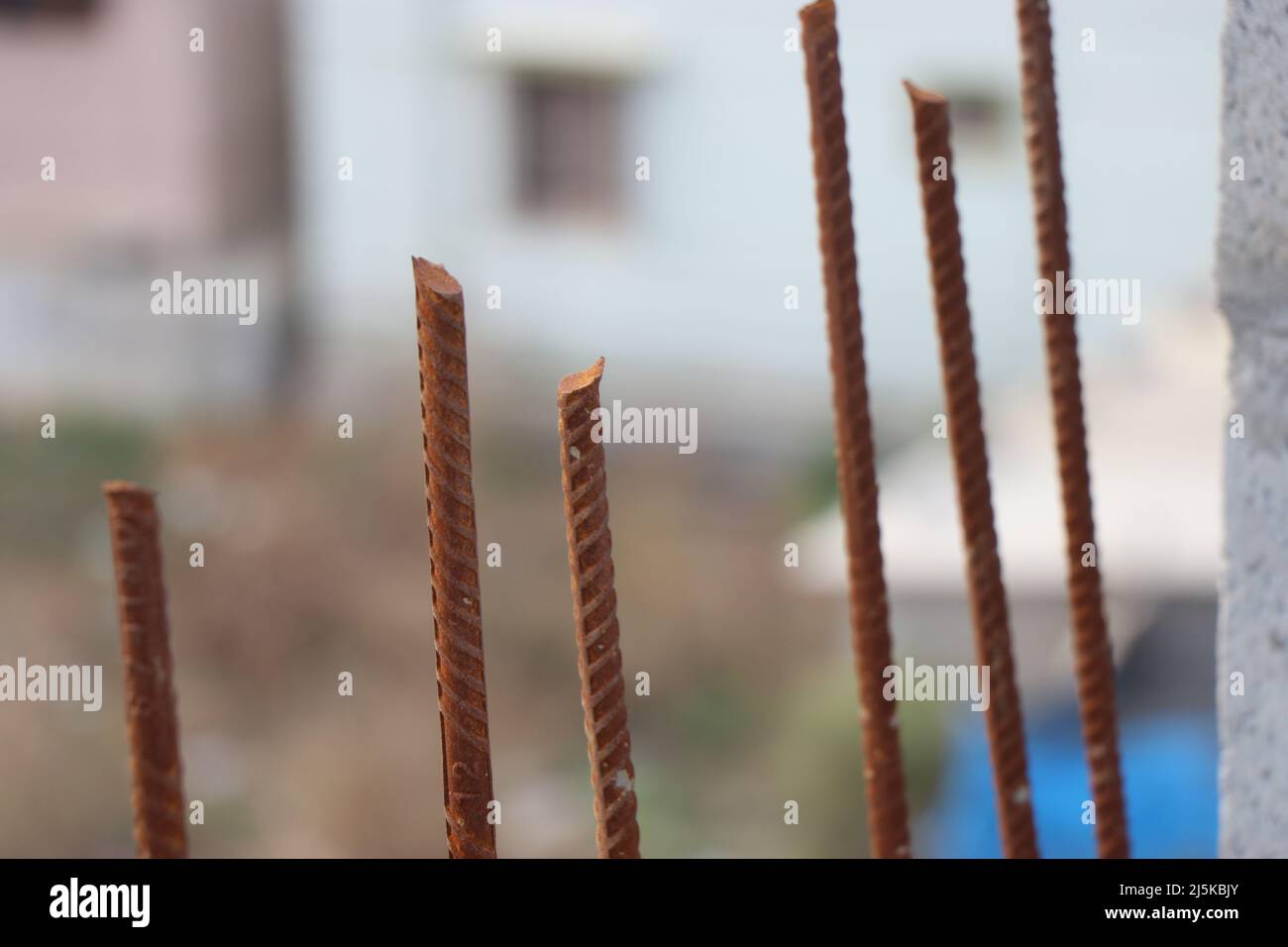 Rusty iron bars from the house pillar that are extended for future ...