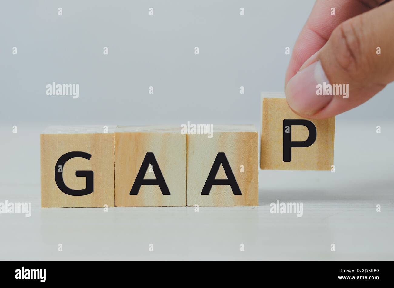 Hand put wooden cubes with GAAP Generally Accepted Accounting ...