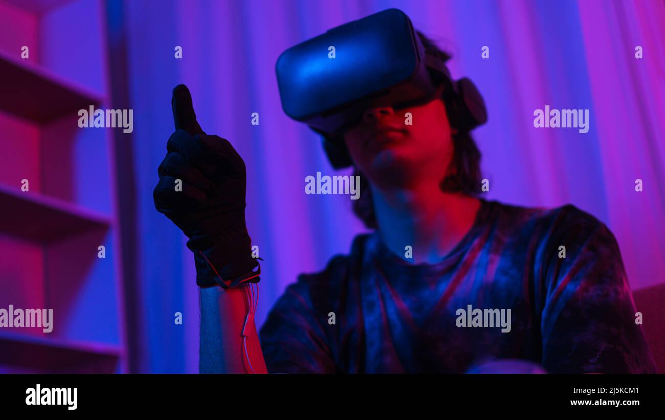 Metaverse technology concept, Man wear VR goggles and glove to making ...