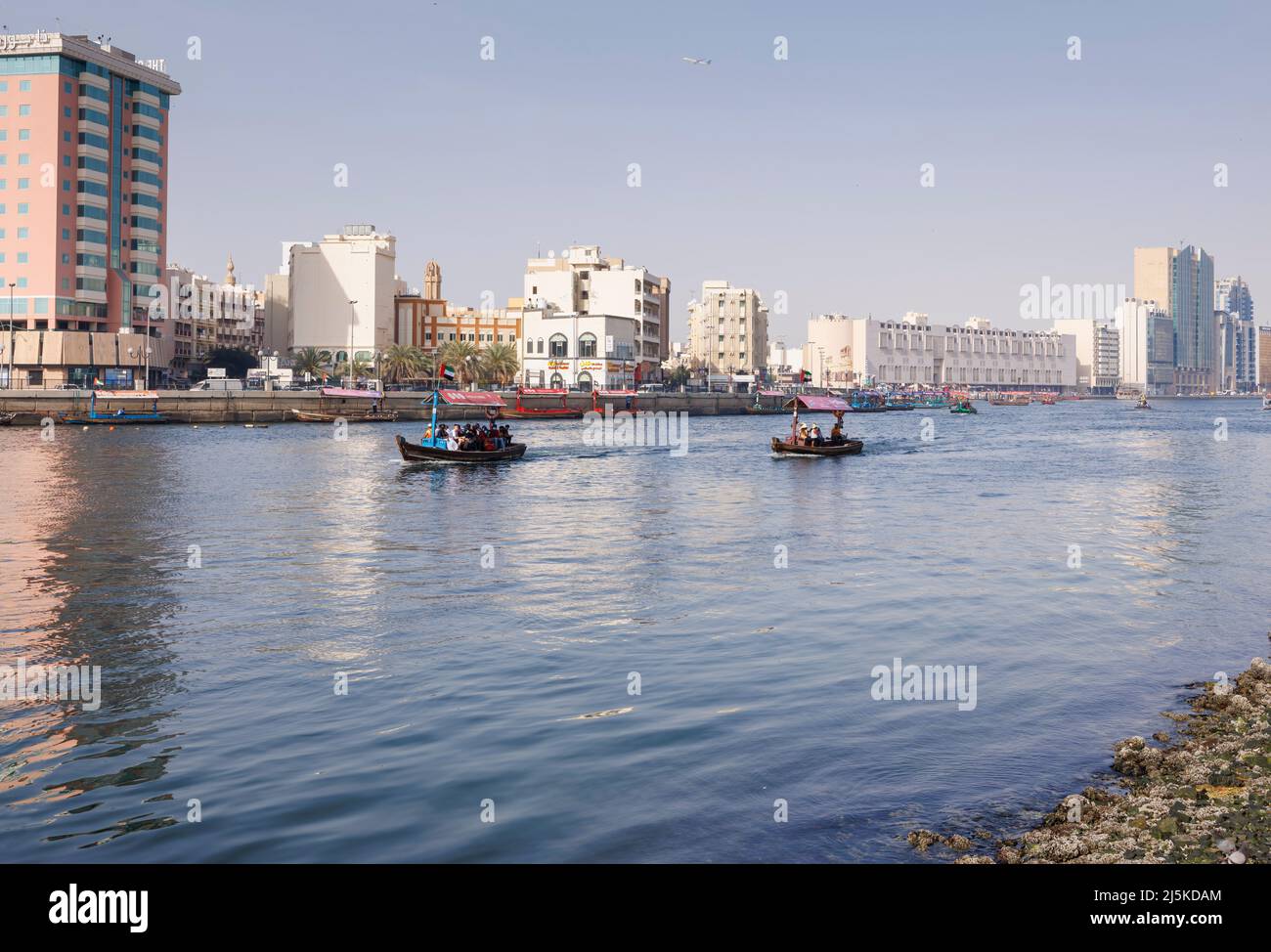 DUBAI, UNITED ARAB EMIRATES - APRIL 9: Abra boats cross the Dubai Creek ...