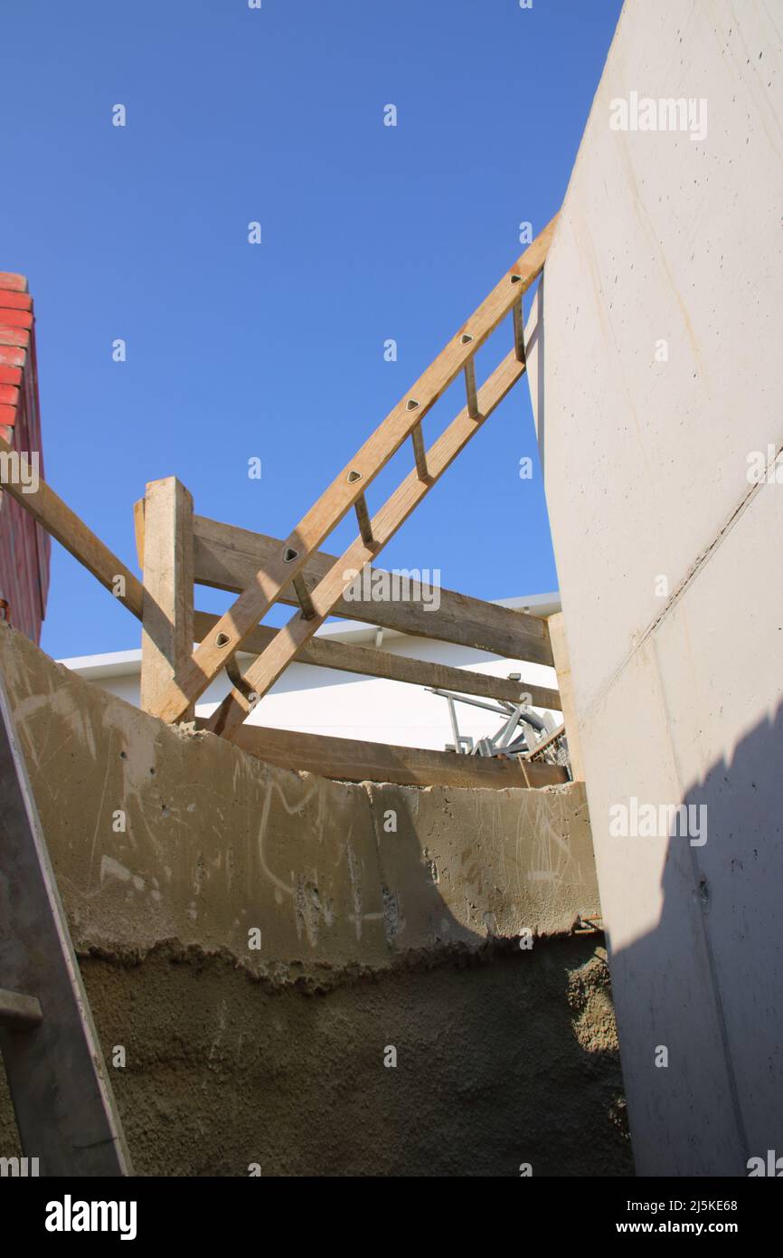 ladder is at risk of falling over a pit Stock Photo - Alamy