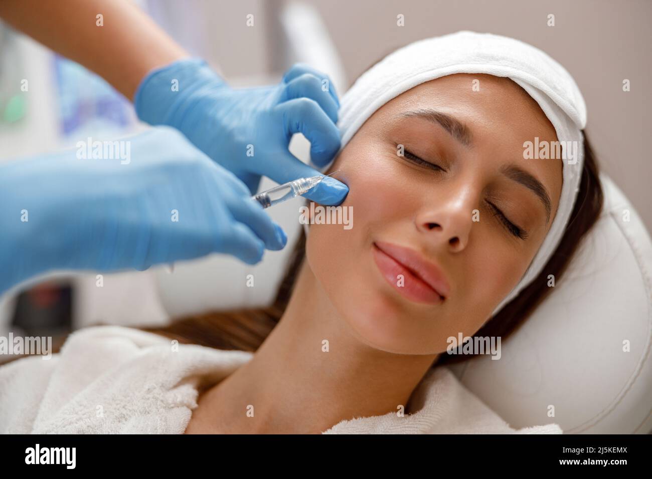 Woman getting injection in her face at plastic surgery clinic Stock ...