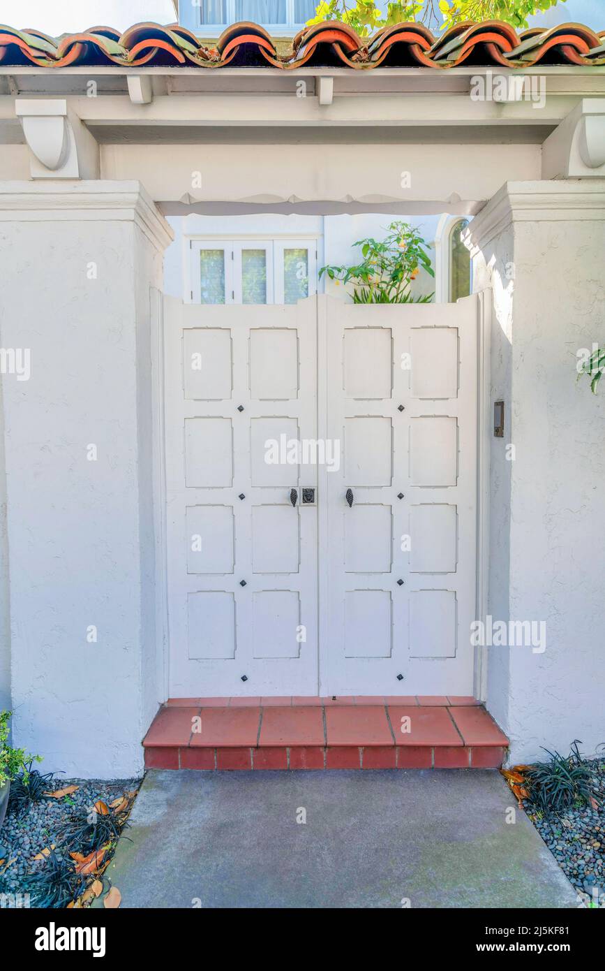 Double wooden white door gate with arbor concrete tile roof at San ...
