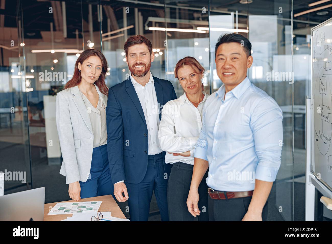 Happy diverse professional business team stand in office near each ...