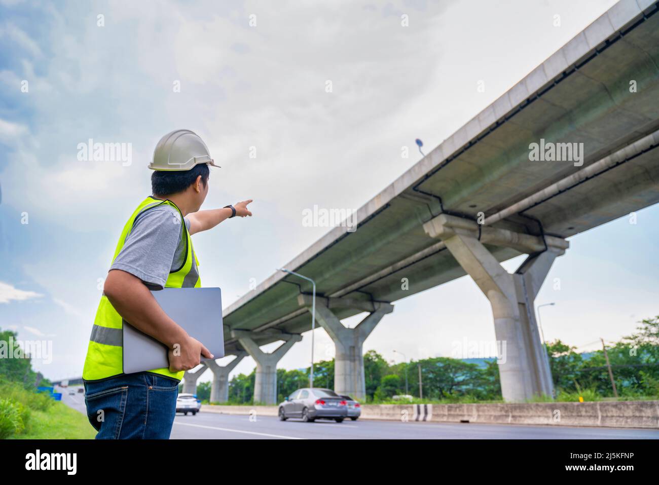 Civil Engineer Architecture holding laptop inspection project road ...