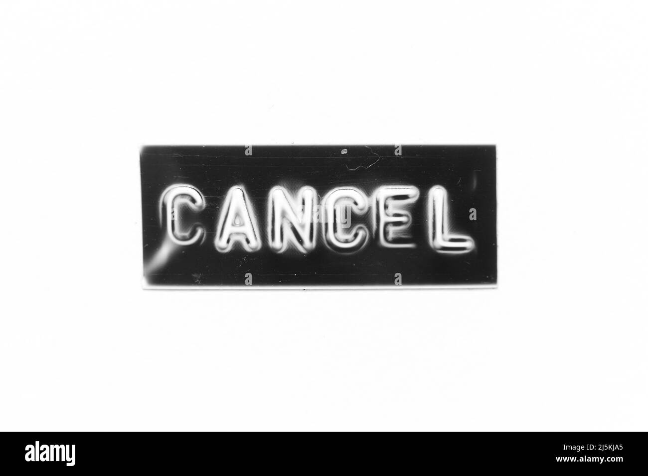 Black color banner that have embossed letter with word cancel on white ...