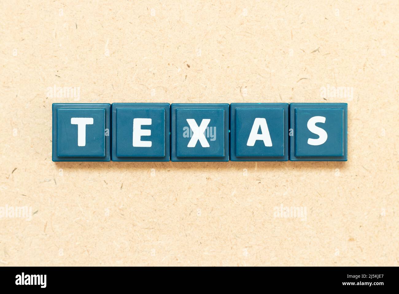 Tile alphabet letter in word texas on wood background Stock Photo - Alamy
