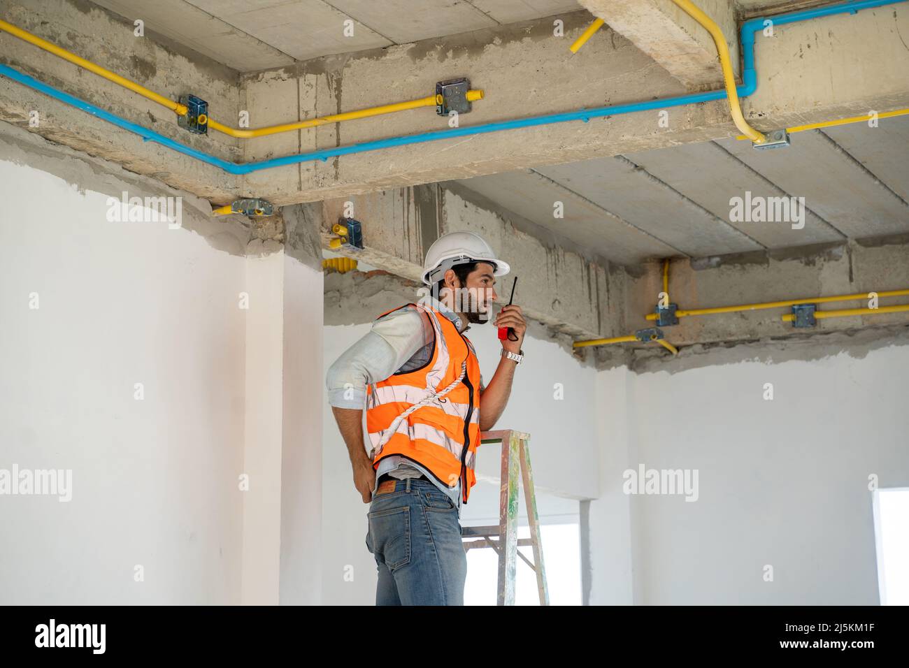 Construction engineering worker talking on radio,Construction engineer ...