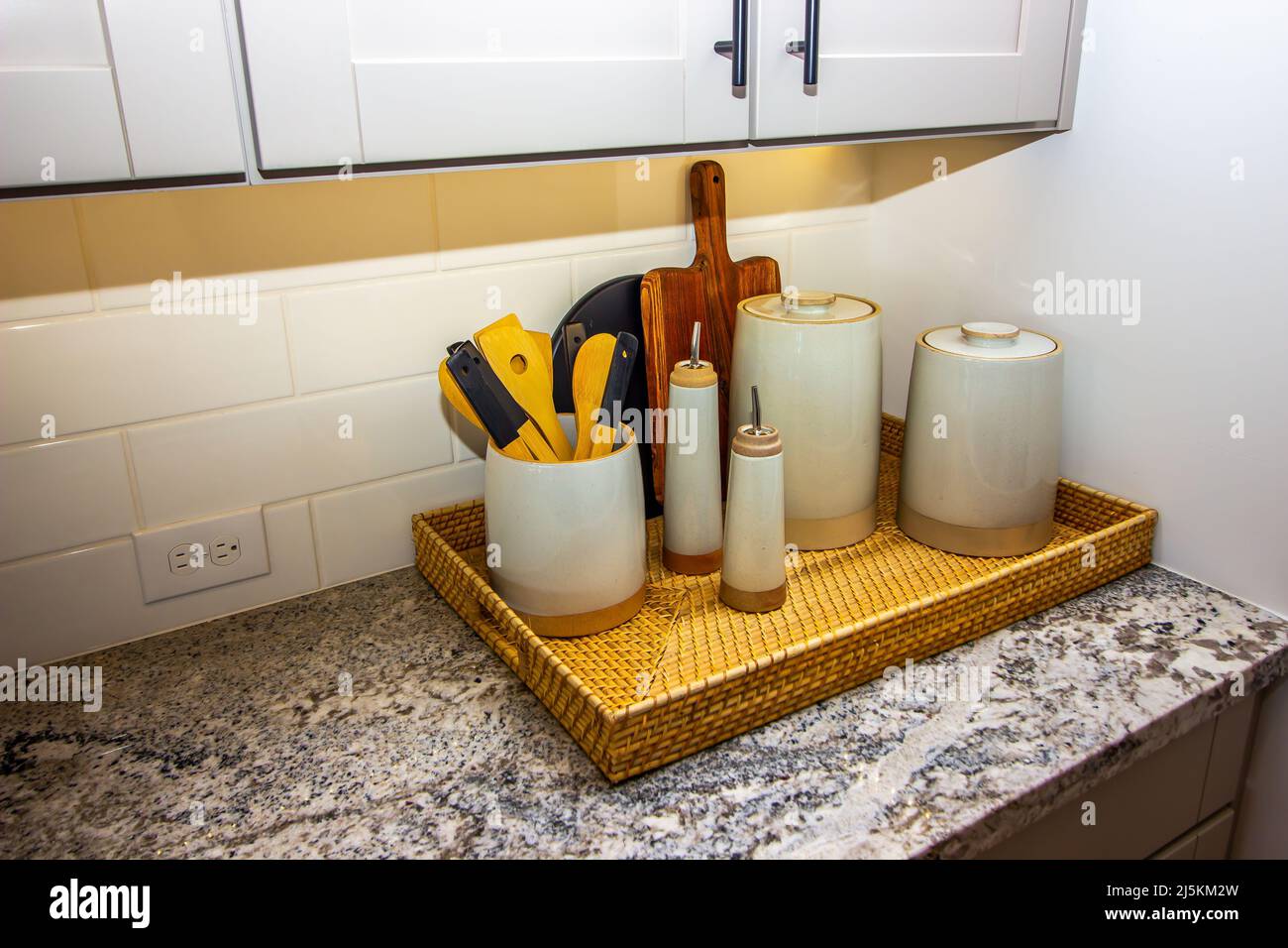 Wicker Basket Of Kitchen Containers On Counter Top Stock Photo - Alamy