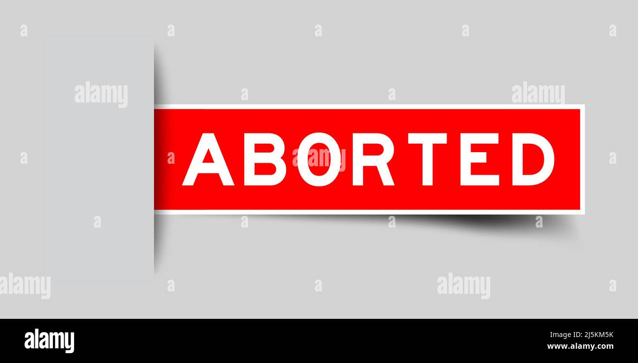 Inserted red color label sticker with word aborted on gray background ...