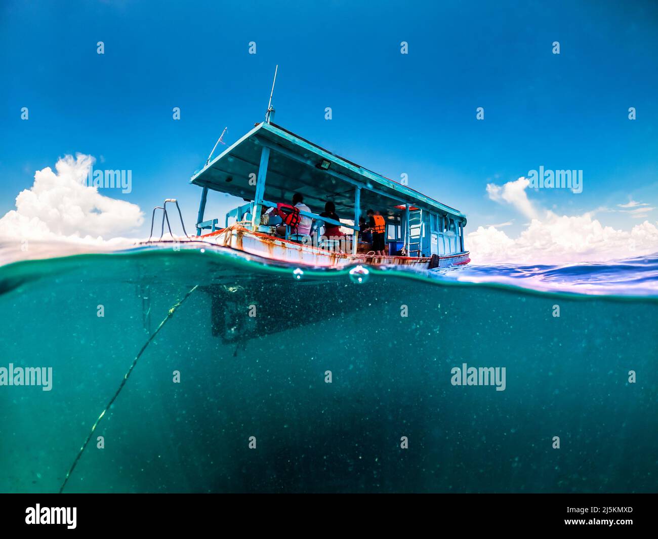 Over under view of seabed scuba diving boat Stock Photo - Alamy