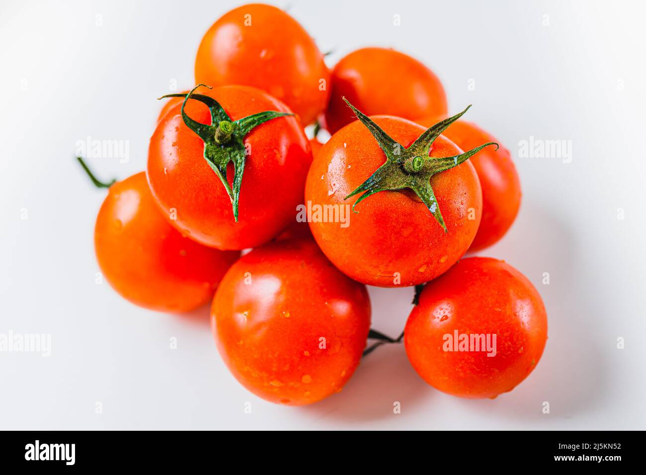 Bunch of ripe tomatoes with one source of natural light. Ripe tomatoes ...