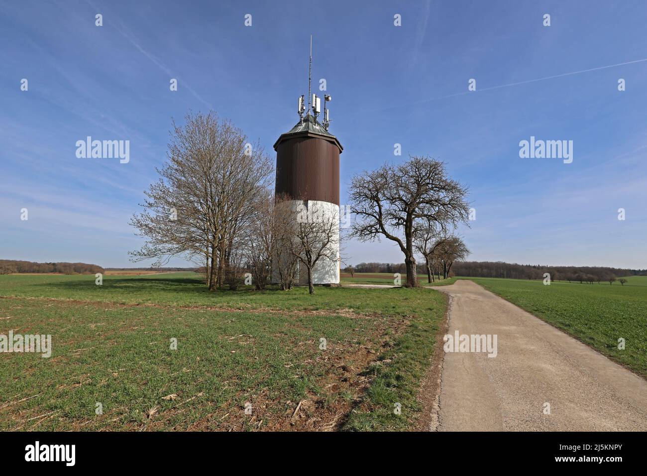 Spring landscape with water tower and road Stock Photo - Alamy