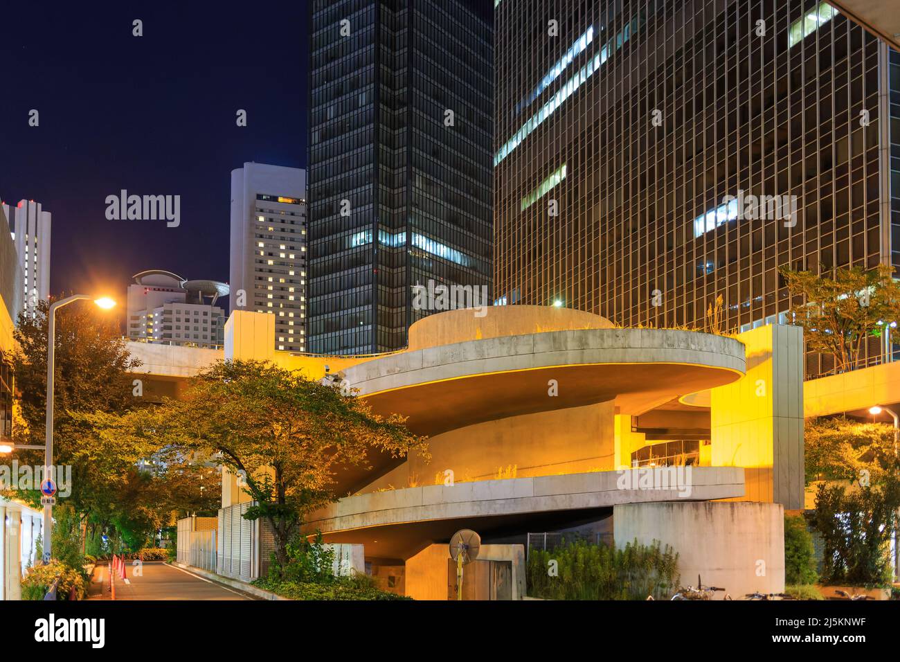 High rise buildings surround parking structure in city center at night ...