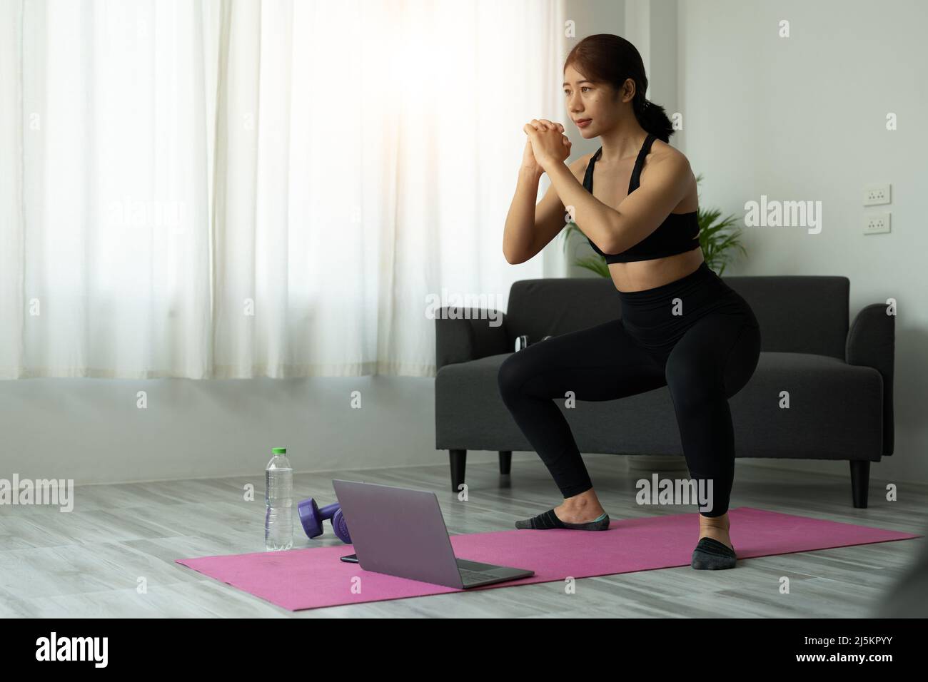 Fit sporty young asian woman online workout exercise at home. Active ...