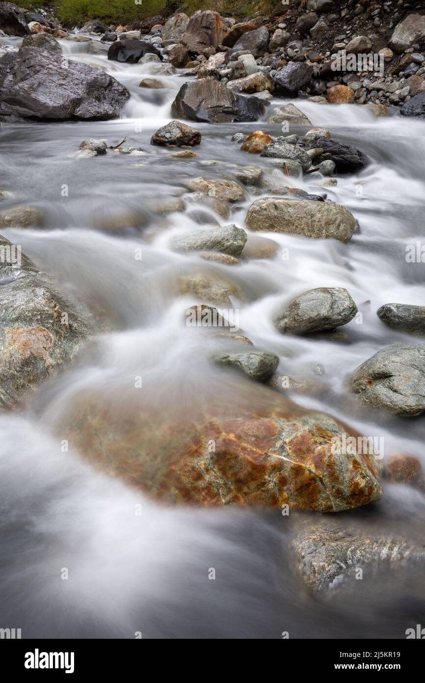 Ice-cold water flows through the valley of Grindelwald Stock Photo - Alamy