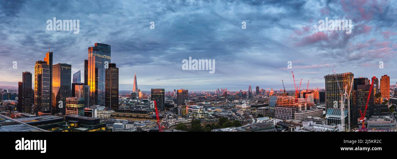 The first rays of sun shine over the City of London Stock Photo - Alamy