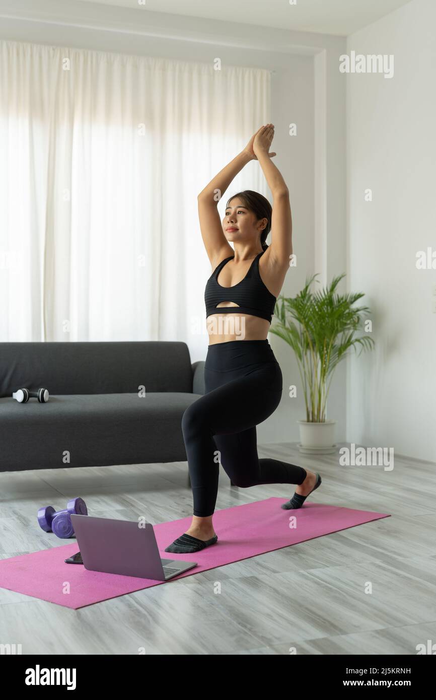 Fit sporty young asian woman online workout exercise at home. Active ...