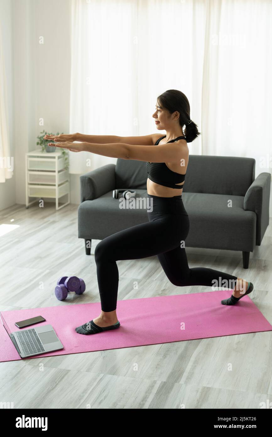 Fit sporty young asian woman online workout exercise at home. Active ...