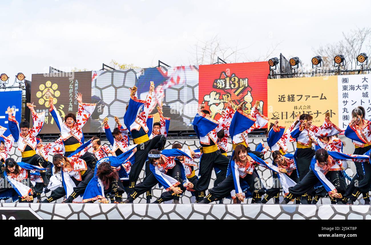 Japanese team of Yosakoi dancers dancing in yukata tunics and holding ...