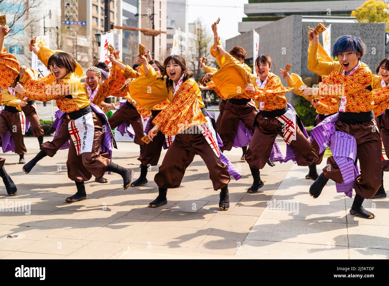 Japanese team of Yosakoi dancers dancing in yukata tunics and holding ...