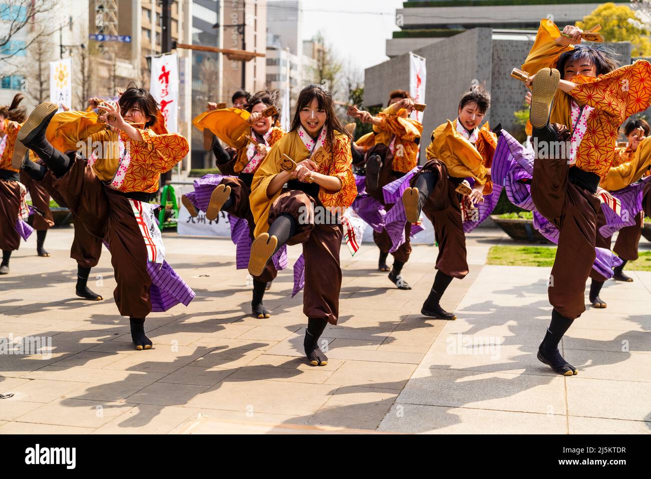 Japanese team of Yosakoi dancers dancing in yukata tunics and holding ...