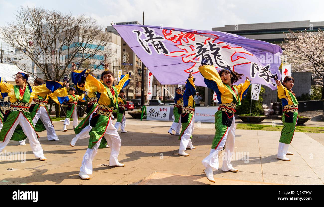 Japanese team of Yosakoi dancers dancing in yukata tunics and holding ...